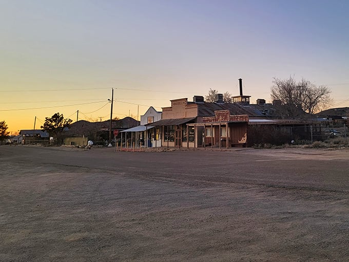 Golden hour light bathes weathered storefronts in warm hues, making this remote outpost feel almost magical.