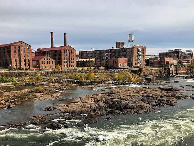 Autumn colors the riverbanks while white water churns past historic brick, blending past and present perfectly.