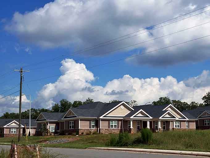 Those puffy clouds floating over modest homes remind us that simple living often brings the richest rewards.