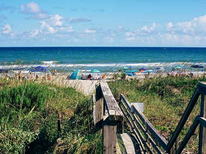 A weathered boardwalk leads through sea grass to turquoise water that practically begs you to dive in.