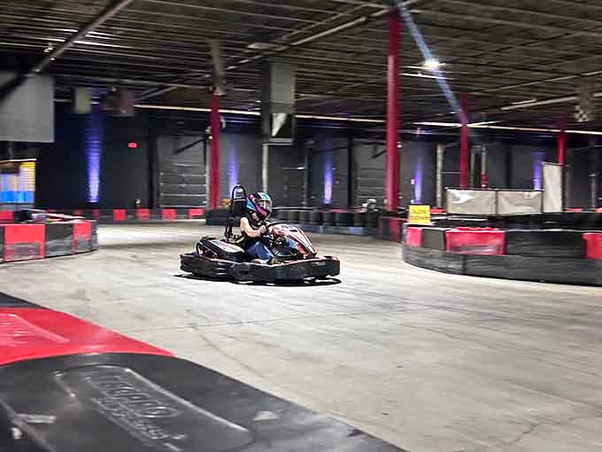 Sleek barriers and dramatic lighting transform this industrial space into a high-speed playground for grown-ups.