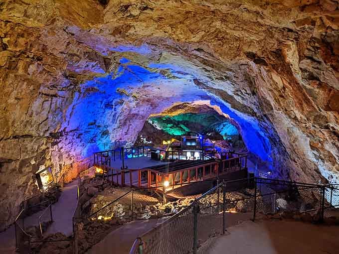 Two hundred feet underground, colored lights transform ancient limestone into an otherworldly cathedral that defies every desert expectation.