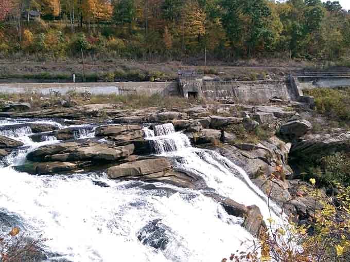 The wide expanse of foaming water spreads across dark ledges like nature's own grand staircase.
