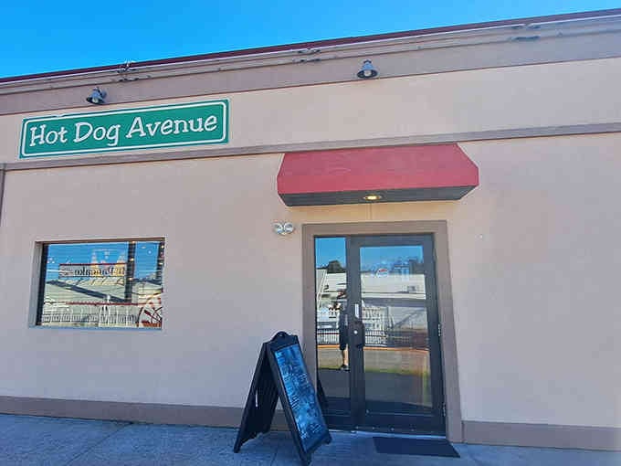 Hot Dog Avenue's simple sign and red awning offer straightforward comfort in the middle of vacation excitement.
