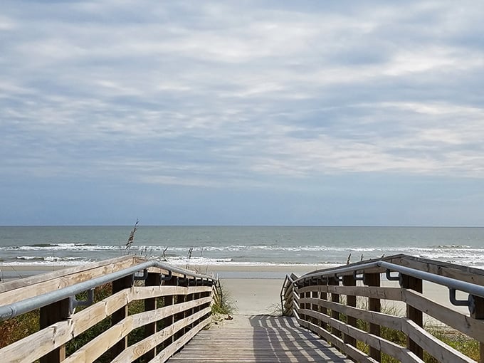 The wooden walkway curves toward the Atlantic like an invitation you simply cannot refuse on a breezy day.