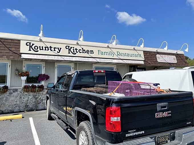 Blue skies frame a family restaurant where pickup trucks in the lot signal serious portions and satisfied appetites.