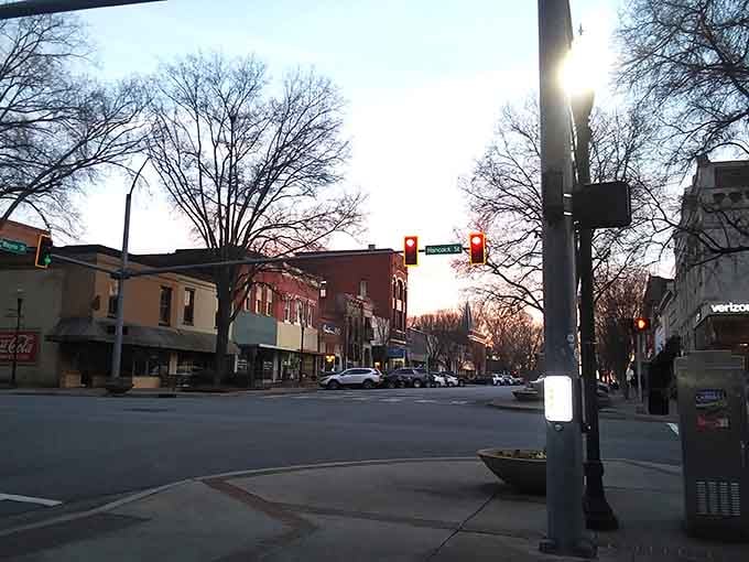 Evening settles over downtown Milledgeville as streetlights flicker on, creating that perfect small-town movie scene we all love.