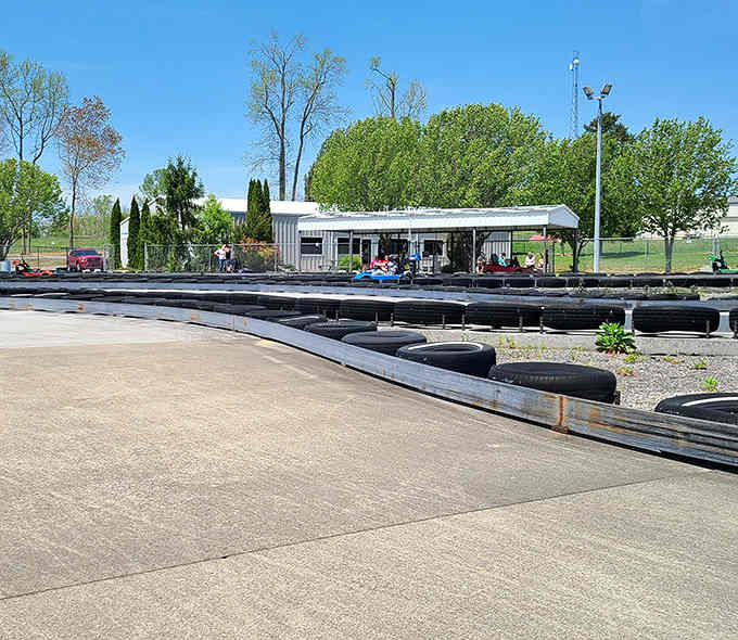 The covered pavilion offers shade for spectators while racers chase glory around those tire-lined curves under open skies.