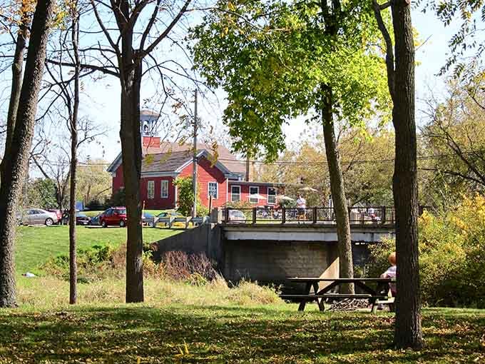 That peaceful bridge and red building framed by fall foliage&mdash;Norman Rockwell would've set up his easel here.
