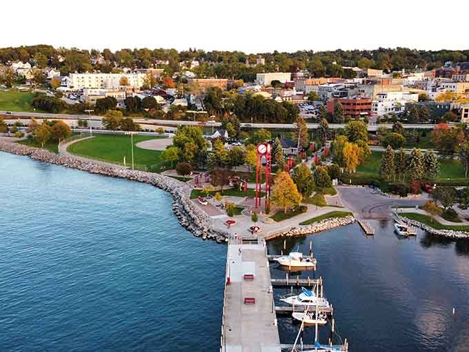 This waterfront view captures boats bobbing peacefully in a harbor framed by parks and historic buildings along the shore.