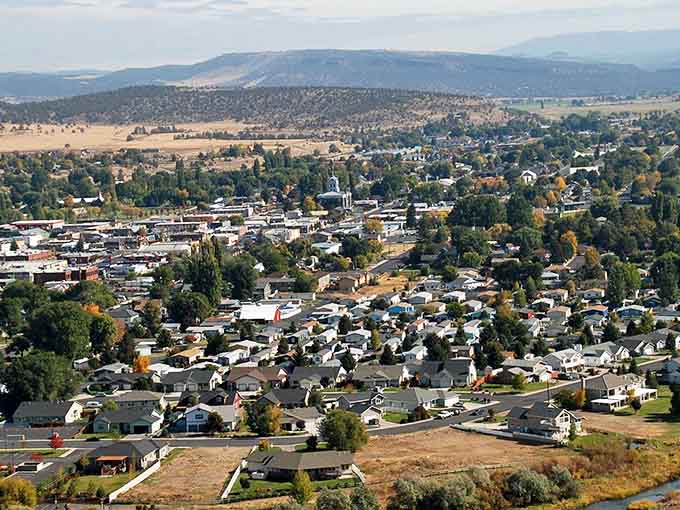 Mountains frame this valley town where neighborhoods nestle among trees like a peaceful postcard scene.