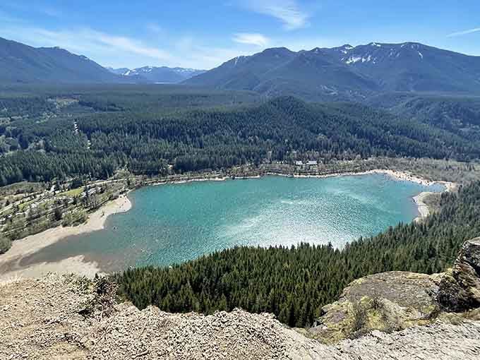 From this rocky perch, Rattlesnake Lake gleams like a turquoise jewel nestled in an endless sea of green.