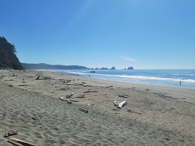 Sun-drenched sand stretches endlessly, with those mysterious rock formations dotting the horizon like ancient sentinels keeping watch.