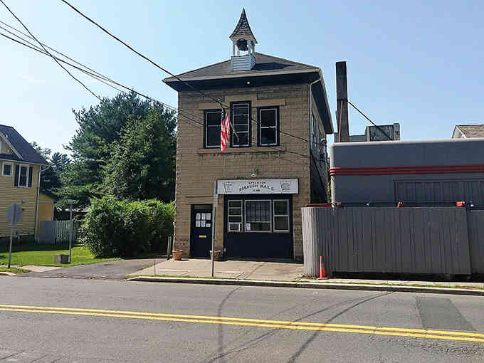 This modest municipal building proves you don't need skyscrapers when you've got character and a friendly wave.