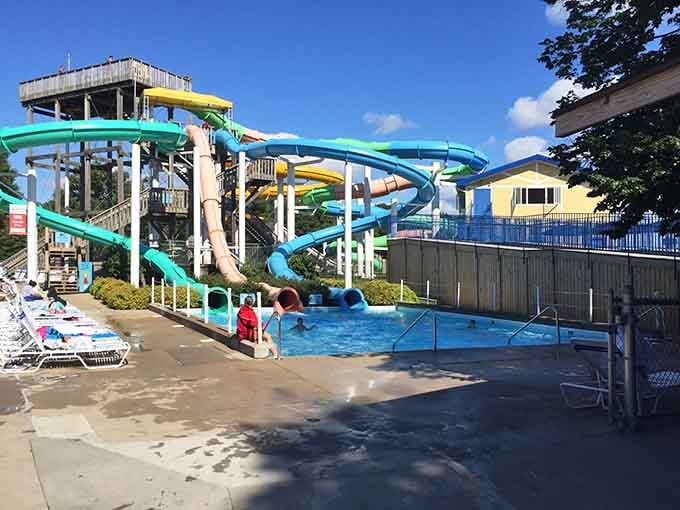 Twisting slides in turquoise and green snake down like a rainbow melted into pure excitement.