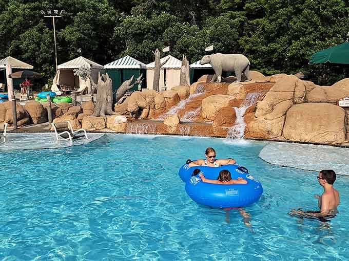 Safari animals watch over the pool from rocky perches, adding whimsical charm to this crystal-blue floating paradise.