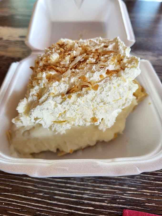 Toasted coconut crowns this towering beauty like snow on a delicious mountain you'll happily climb with your fork.