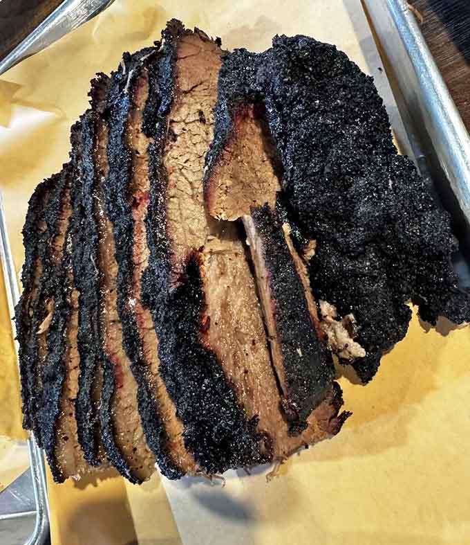 Behold the brisket bark that dreams are made of, dark as midnight and tender as a love song.