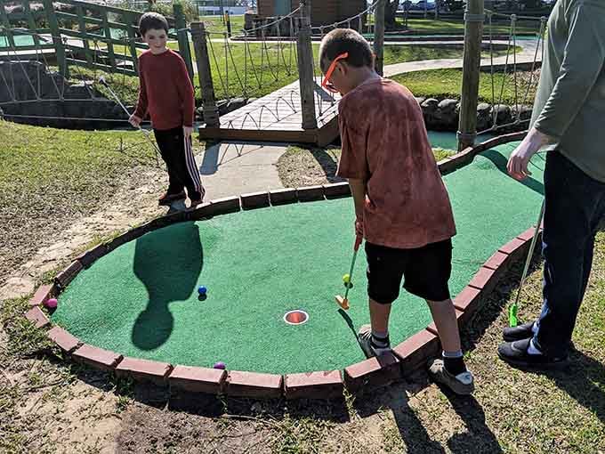 Mini golf: where family competition gets real and nobody's keeping score except absolutely everyone playing.