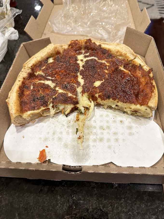 That cross-section reveals the architectural marvel that is authentic Chicago-style deep dish done right in Indiana.