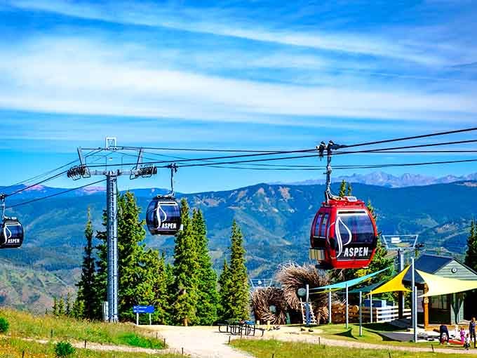 Colorful gondola cabins promise mountain-top adventures, carrying visitors skyward for views that justify the ticket price.