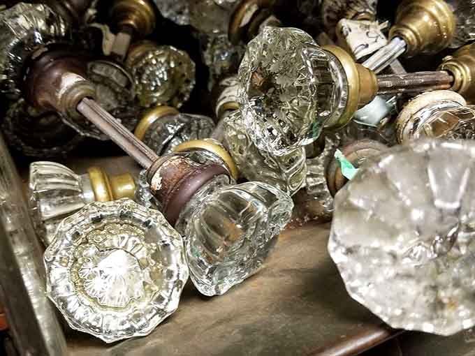 Vintage glass doorknobs that once welcomed guests into homes now sparkle like forgotten jewelry in displays.