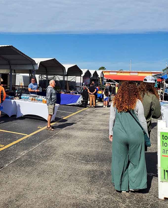 Fellow treasure hunters navigate the outdoor stalls where deals bloom under the Florida sky like bargain flowers.