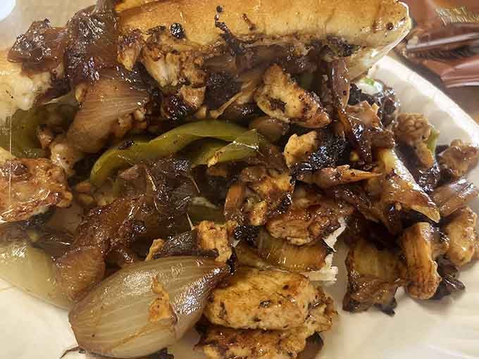Grilled chicken and vegetables piled high enough to require architectural support and possibly a building permit.