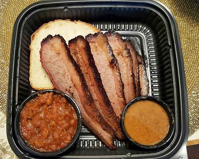 Sliced brisket with that perfect smoke ring, tender enough to make a Texan weep tears of joy.