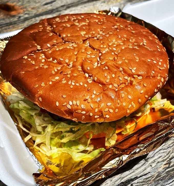 The Super Bubba Burger lives up to its name, towering like Everest with enough beef to satisfy any appetite.