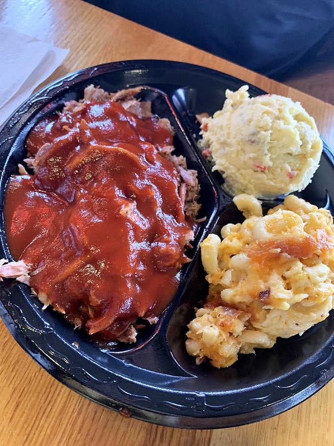 Chopped pork glistening with sauce alongside creamy sides is the definition of Southern comfort done right.