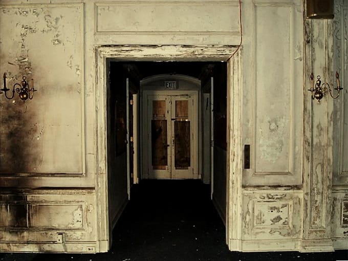 Elegant doorways framed by weathered panels whisper stories of everyone who passed through them before.