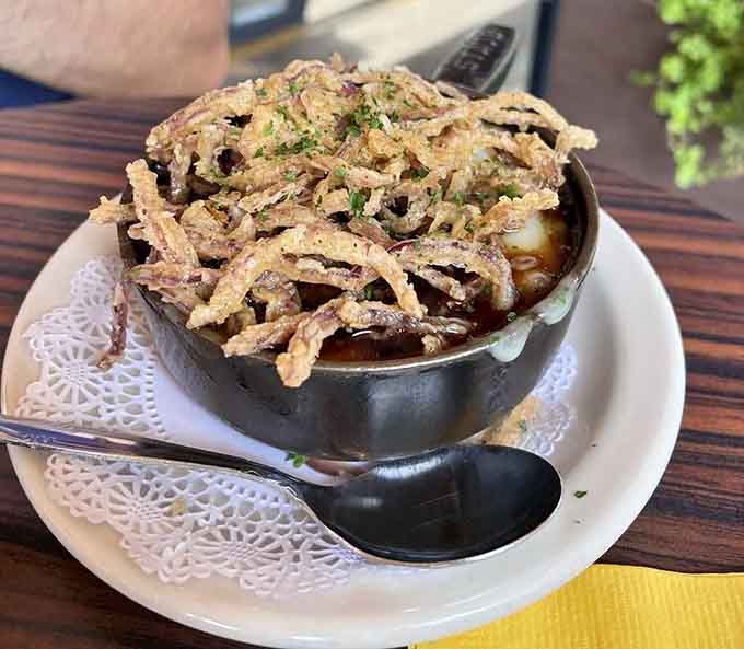 French onion soup topped with crispy onions because sometimes tradition needs a delicious upgrade and nobody's complaining about it.