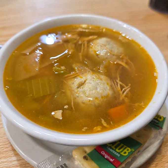 Two matzo balls floating in golden broth like delicious life rafts ready to rescue your soul.