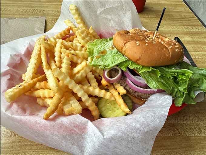 A burger this loaded with fresh toppings and crispy fries is basically a vacation for your taste buds.
