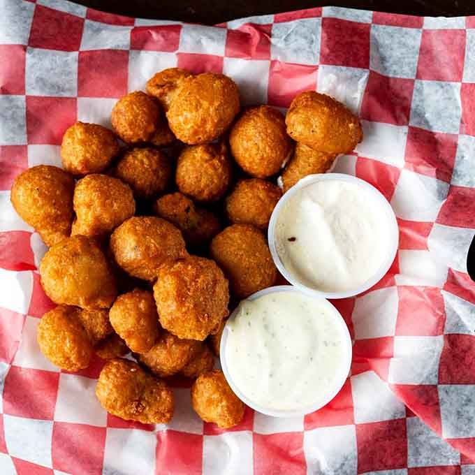Golden tater tots arrive perfectly crispy with creamy dipping sauces, because some joys are truly timeless.