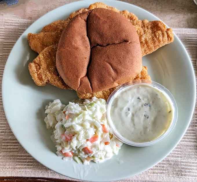 Golden catfish on a soft bun with creamy slaw, this sandwich has earned its legendary status.