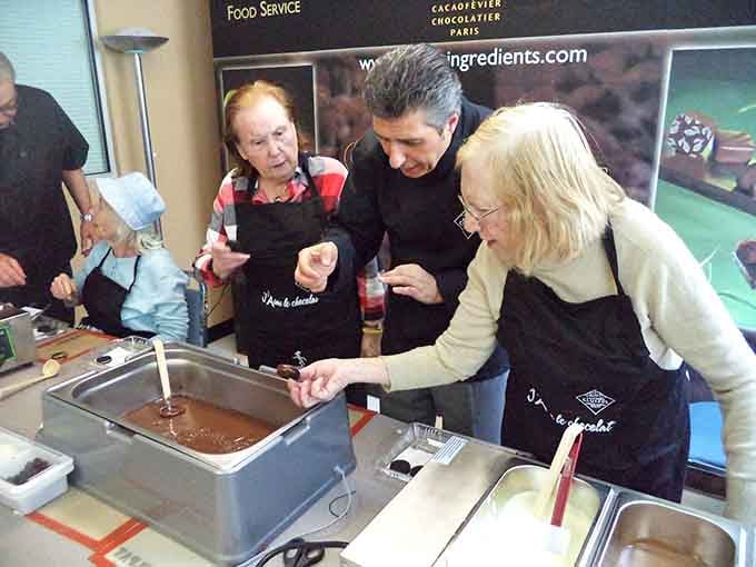 Hands-on chocolate dipping turns everyone into artisans, proving you're never too old to play with your food professionally.