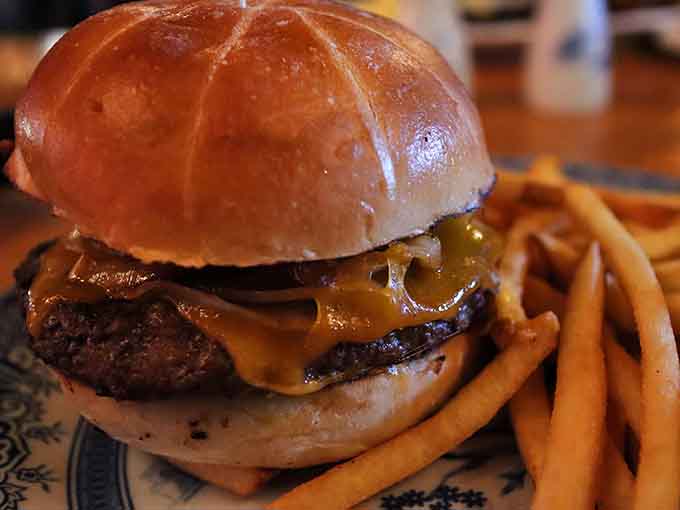 That glossy pretzel bun cradling caramelized onions and melted cheese could make a vegetarian reconsider their life choices.