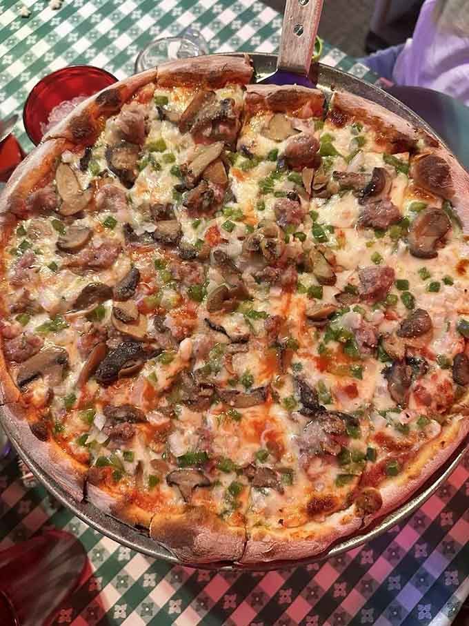Mushrooms, sausage, and peppers dance across melted cheese in this perfectly balanced flavor symphony.