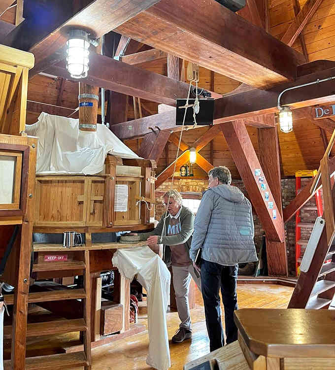 Visitors explore the inner workings where wind power meets old-world engineering in spectacular fashion.