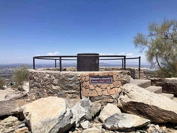 The stone sign marks your arrival at elevation perfection, where regular shoes beat hiking boots every single time.