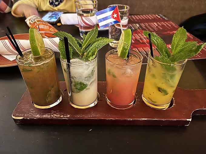Four mojitos lined up like the Rat Pack, each with fresh mint standing tall and ready to party.