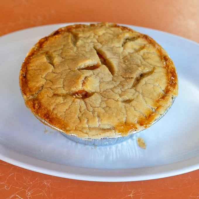 Golden crust meets fruit filling in this individual pie that's basically happiness baked into a portable aluminum tin of joy.