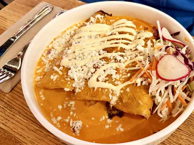 Swimming in rich sauce and topped with cheese, these enchiladas are comfort food at its finest.