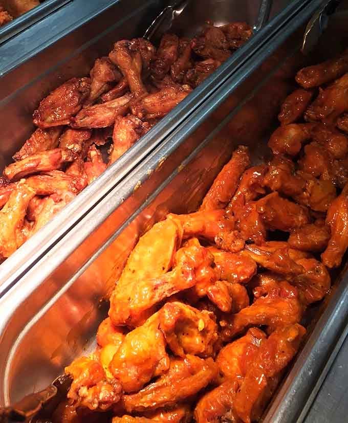 Wings glistening with sauce, ready to deliver flavor that'll have you licking your fingers shamelessly.