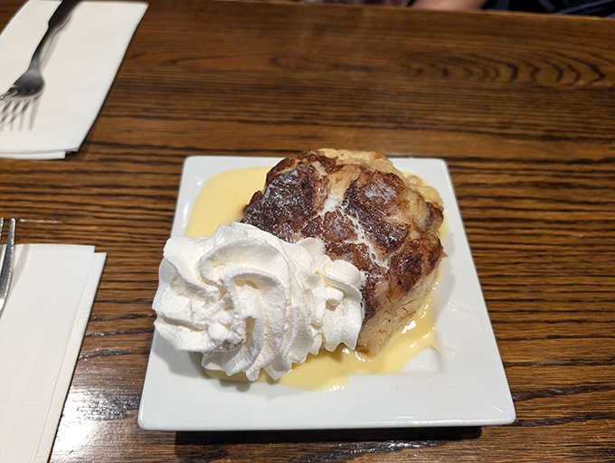 Bread pudding with whiskey sauce and whipped cream, because sometimes dessert needs to give you a warm hug.