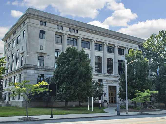 Classical columns and stately windows evoke the grandeur of civic architecture when craftsmanship truly mattered most.