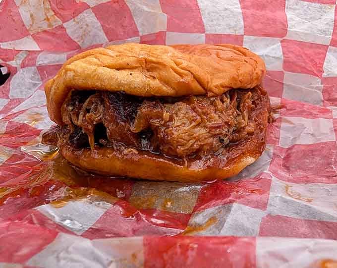 Pulled pork piled so high it's practically defying the laws of sandwich physics and gravity combined.