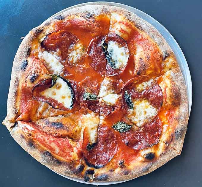 The Margherita proves that sometimes the simplest combination creates the most memorable pizza experience you'll have.